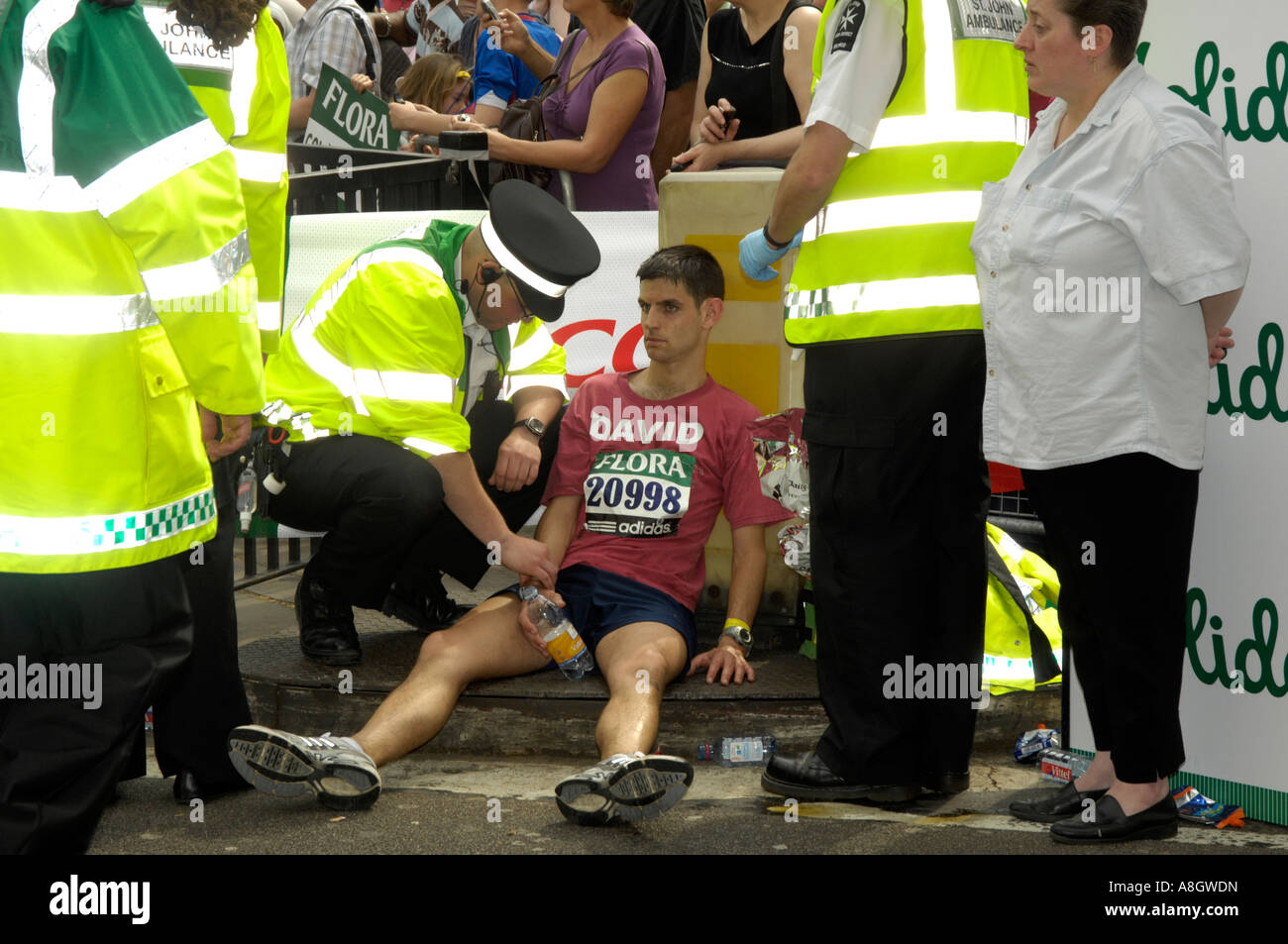 exhausted runner at the Flora London marathon being attended to by ...