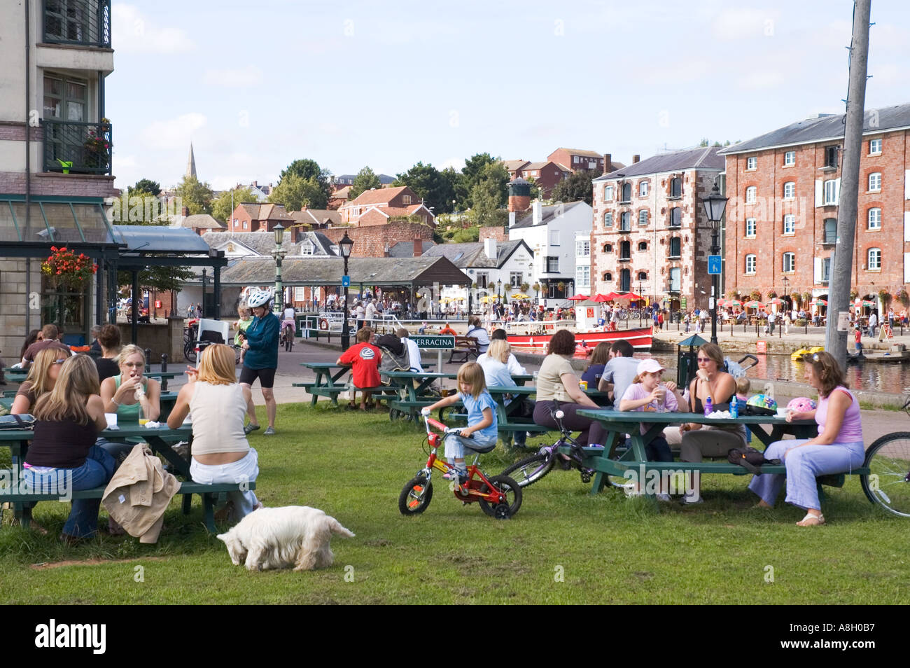 People relax at an outdoor cafe at The Quay, River Exe, Exeter, Devon ...