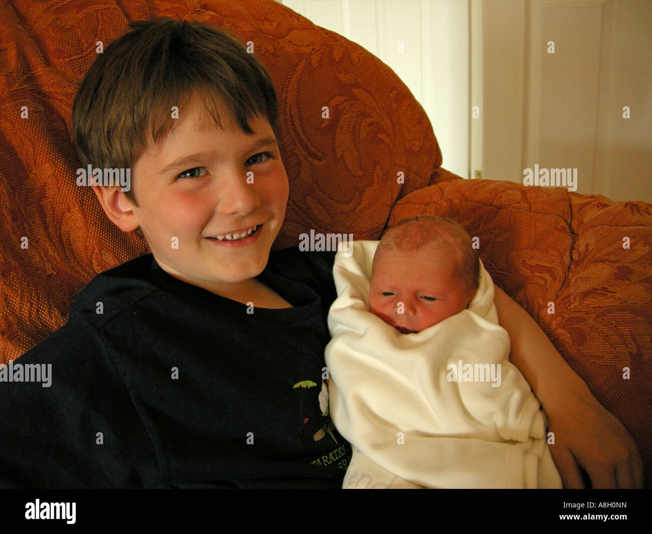 YOUNG BOY with new brother one month old Stock Photo - Alamy
