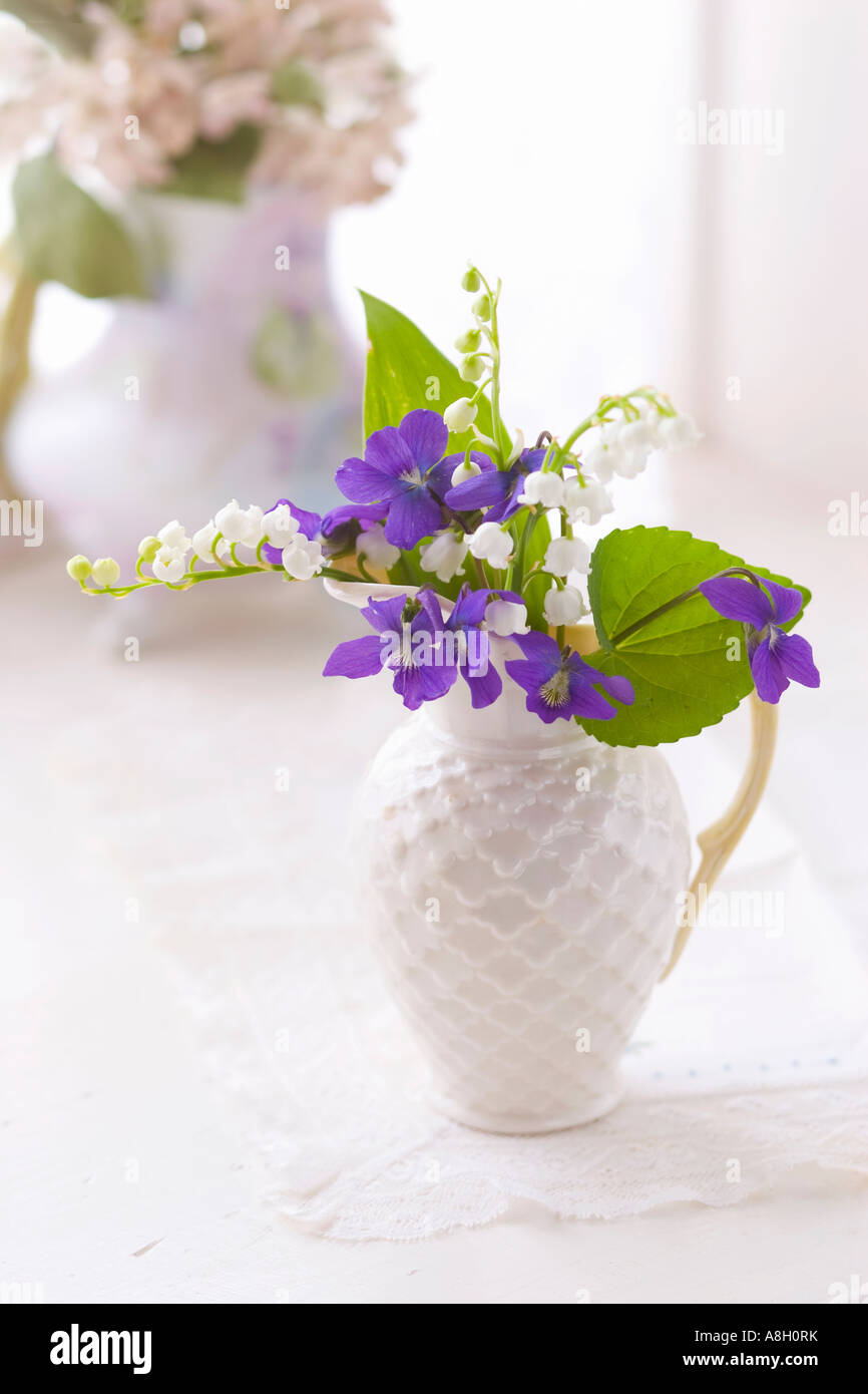 Floral arrangement of Violets and Lily of the Valley in a tiny china ...