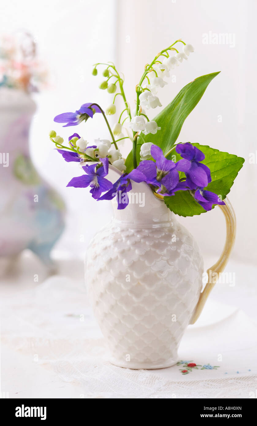 Floral arrangement of Violets and Lily of the Valley in a miniature ...