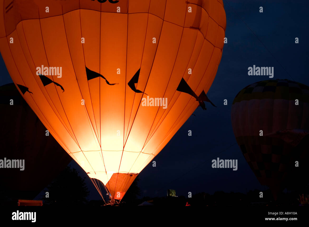 Hot air balloon taking off at night Stock Photo - Alamy