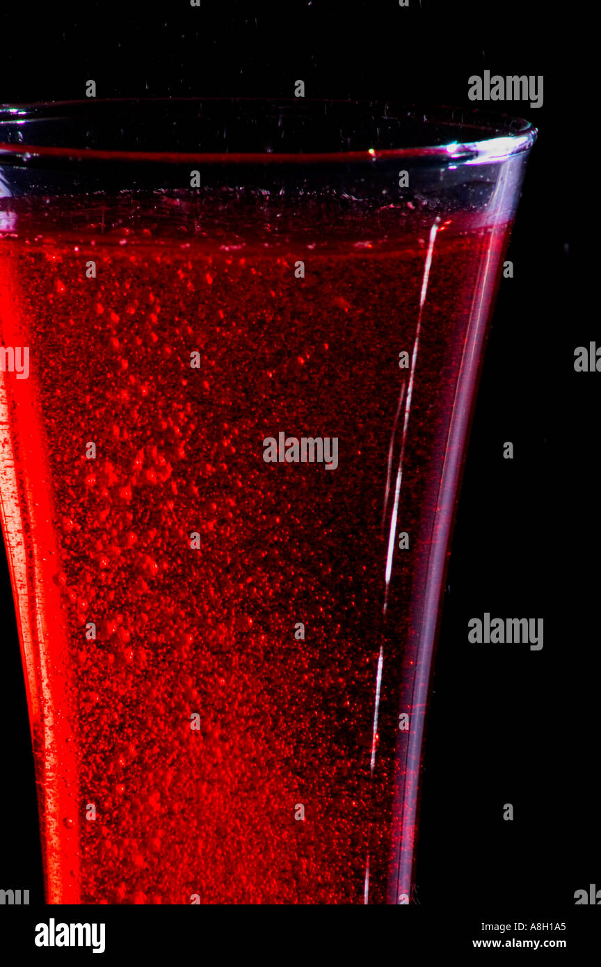 Glass of red liquid with tiny rising bubbles studio still life Stock ...