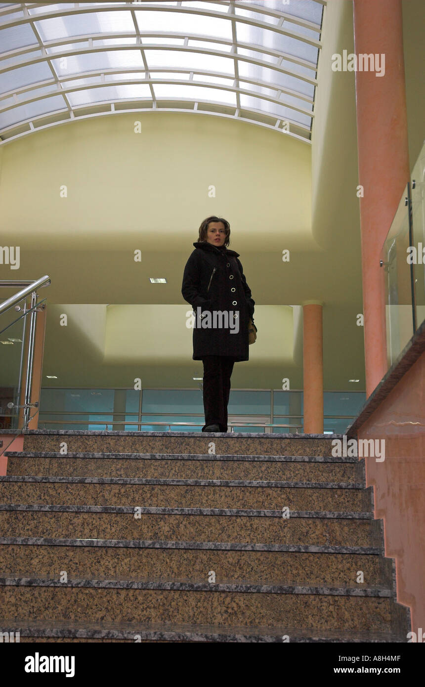 Woman standing on top of stairs hi-res stock photography and images - Alamy