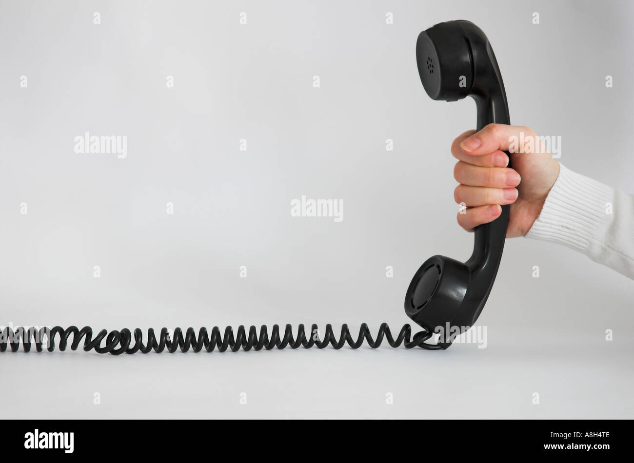 Hand holding telephone receiver Stock Photo - Alamy