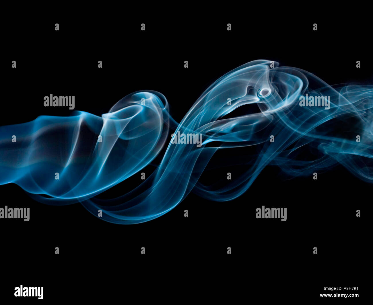 Abstract fish - Colorized incense smoke trails on a black background ...