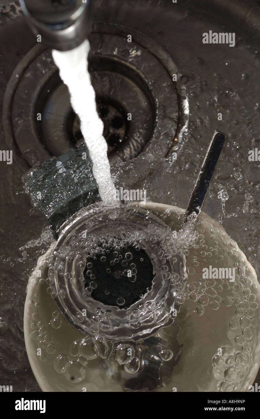 And tap with jet in a cup in the kitchen Stock Photo - Alamy