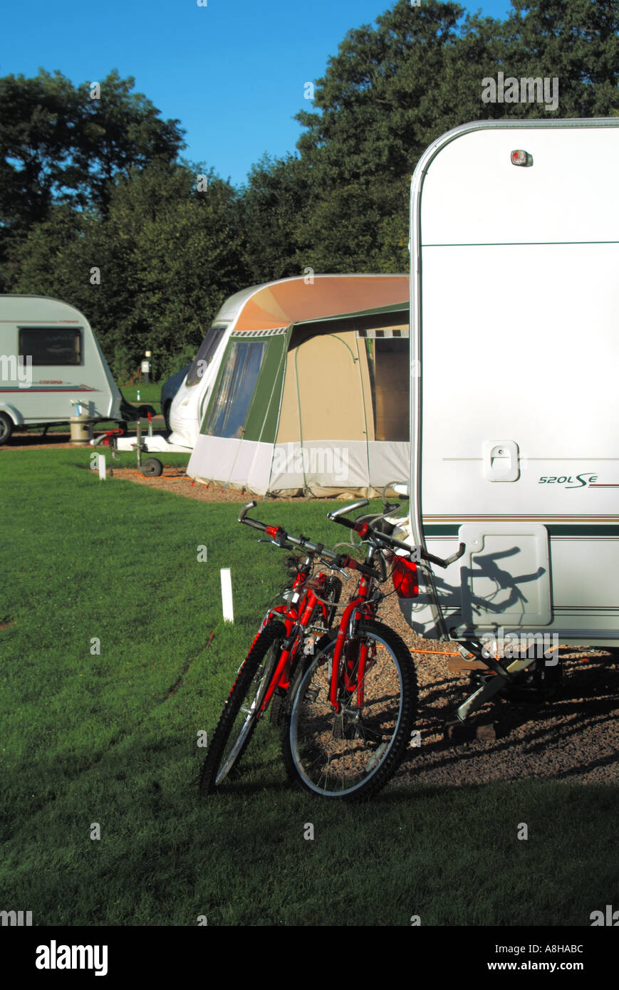 Caravan site with parked cycles leaning against holiday caravan early ...