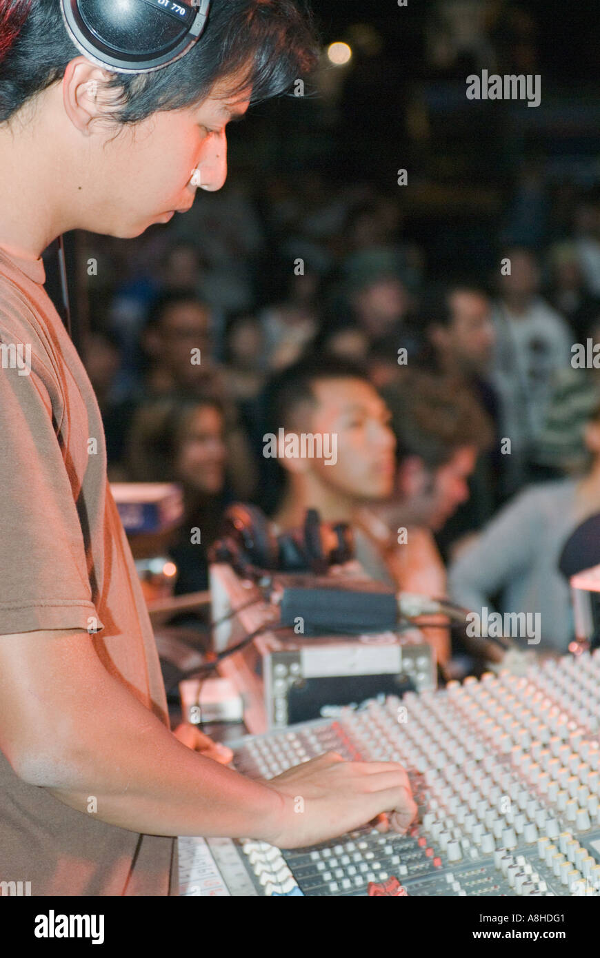 Portrait of sound man working mixing console desk at outdoor rock n ...