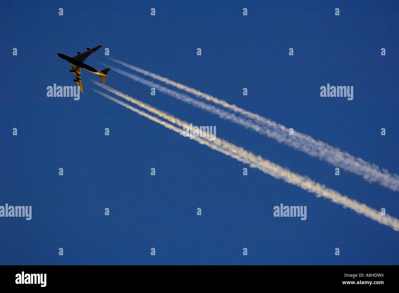 High flying airplane in the morning Stock Photo - Alamy