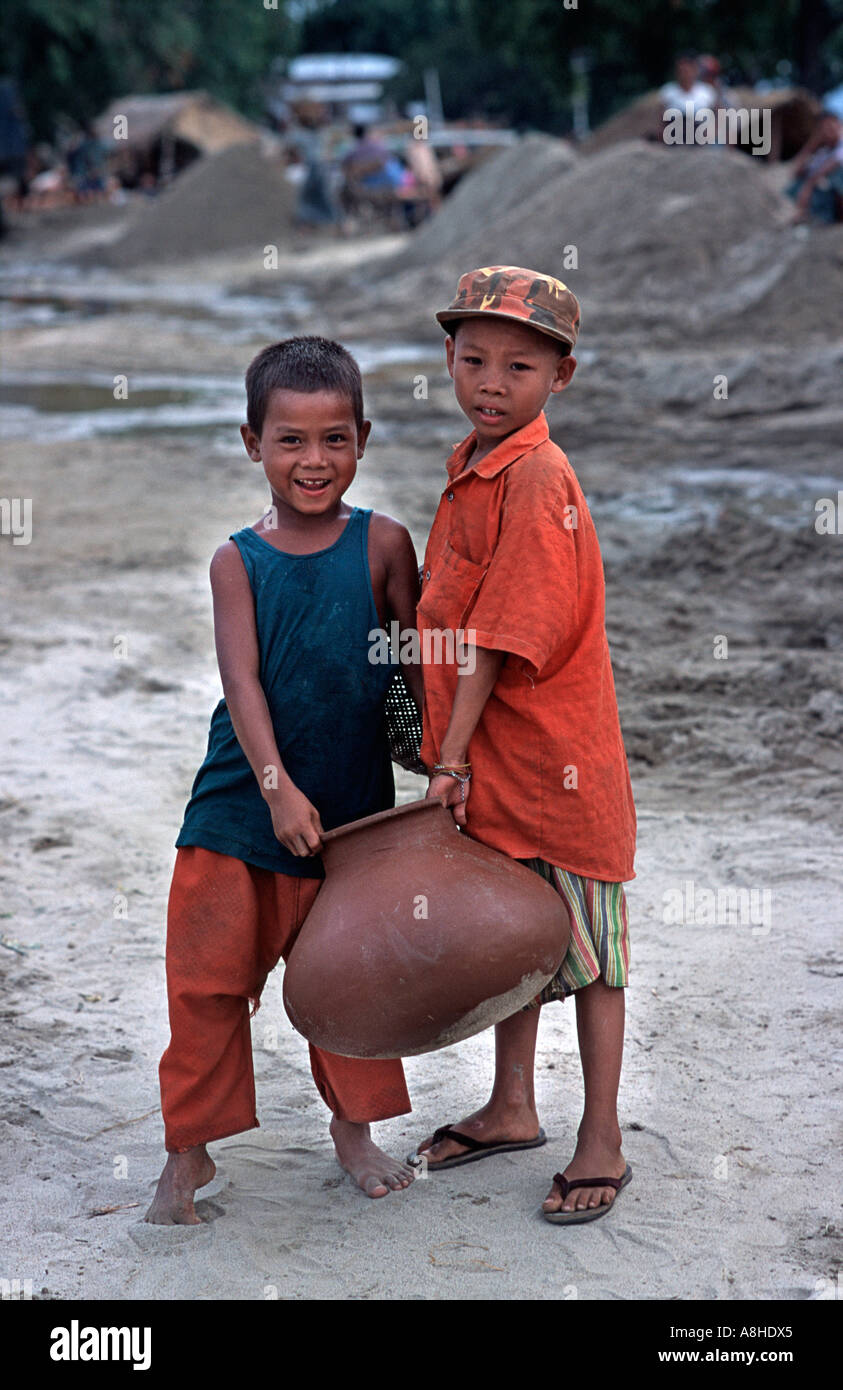 Friendly burmese boys carrying a large ceramic water pot Mandalay ...