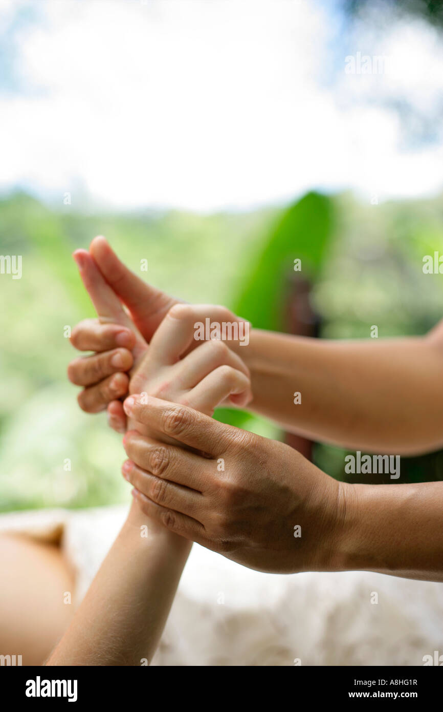 A massage therapist massaging hands and fingers Stock Photo - Alamy