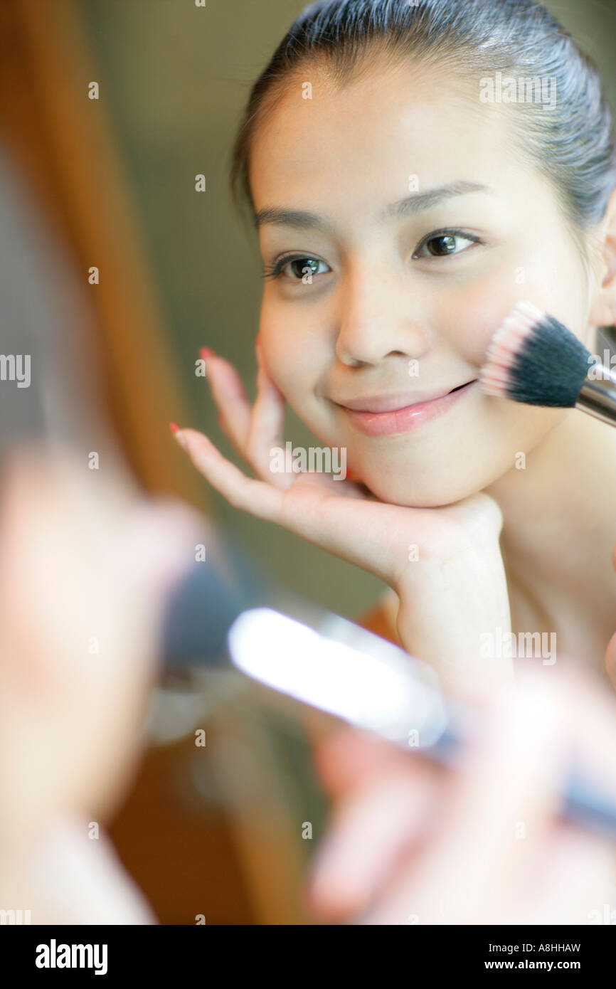 View of a young woman doing makeup Stock Photo - Alamy
