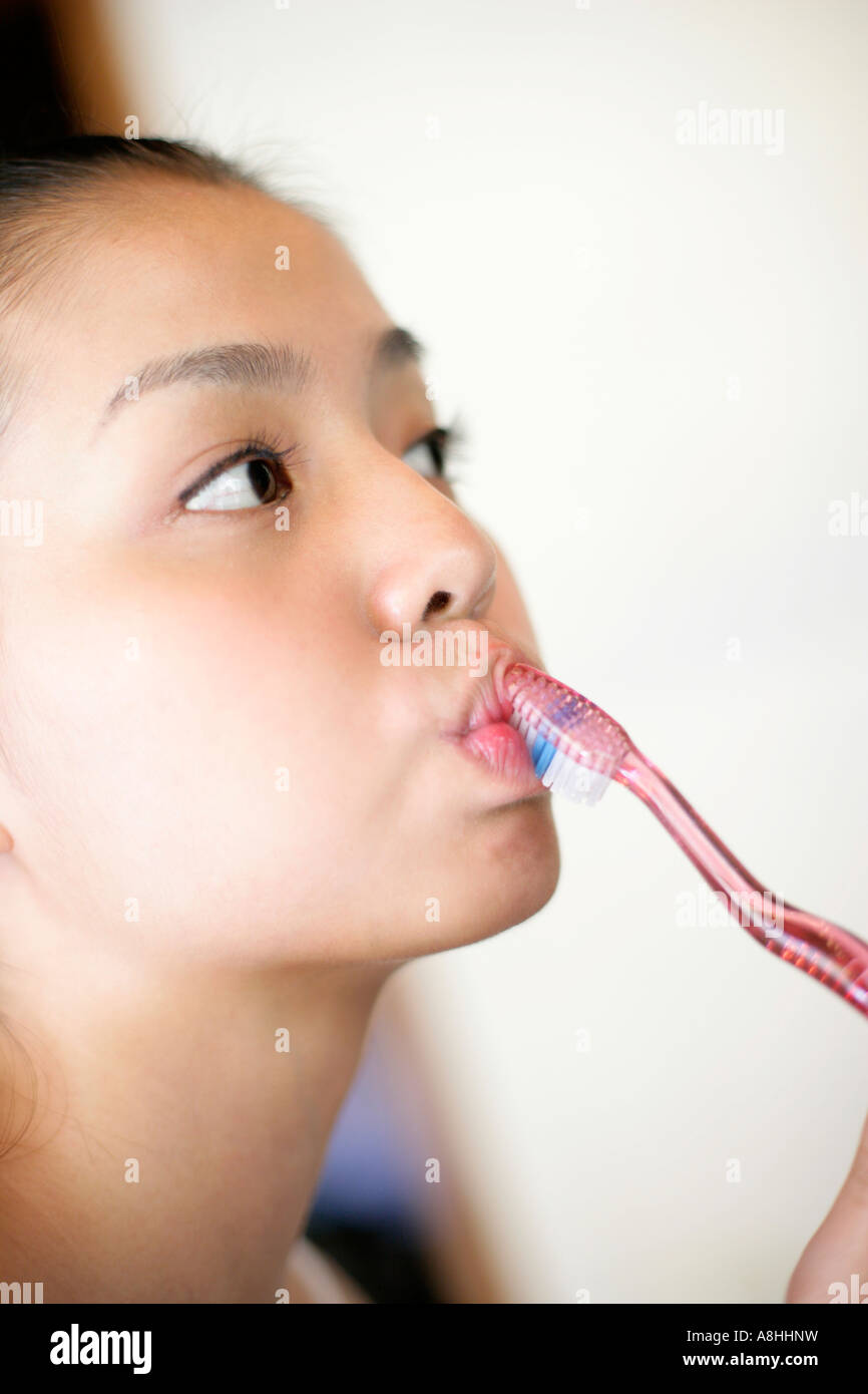 Close up of a young woman brushing teeth Stock Photo - Alamy