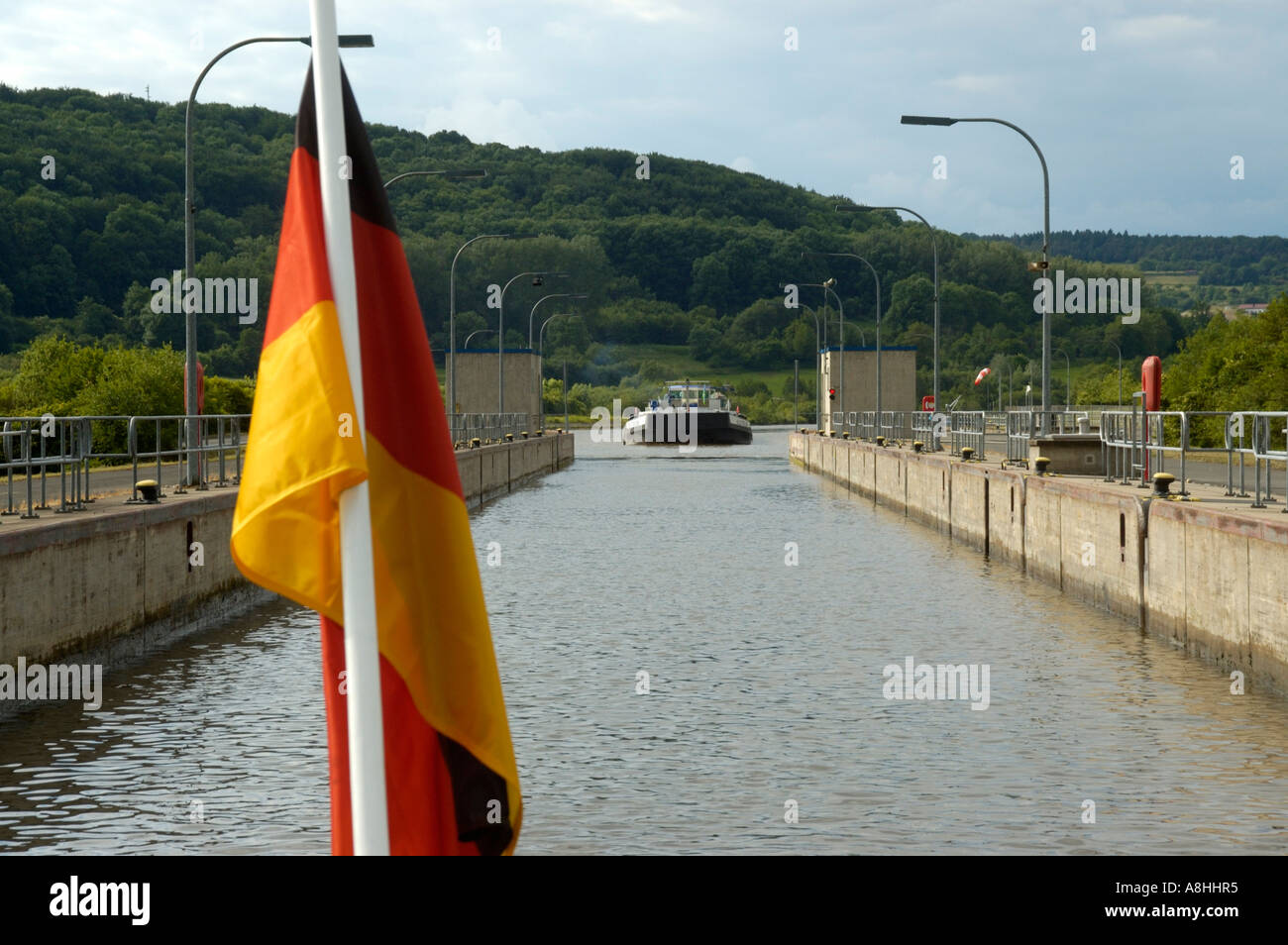 German national flag with sluice watergate and incoming boat on Main ...