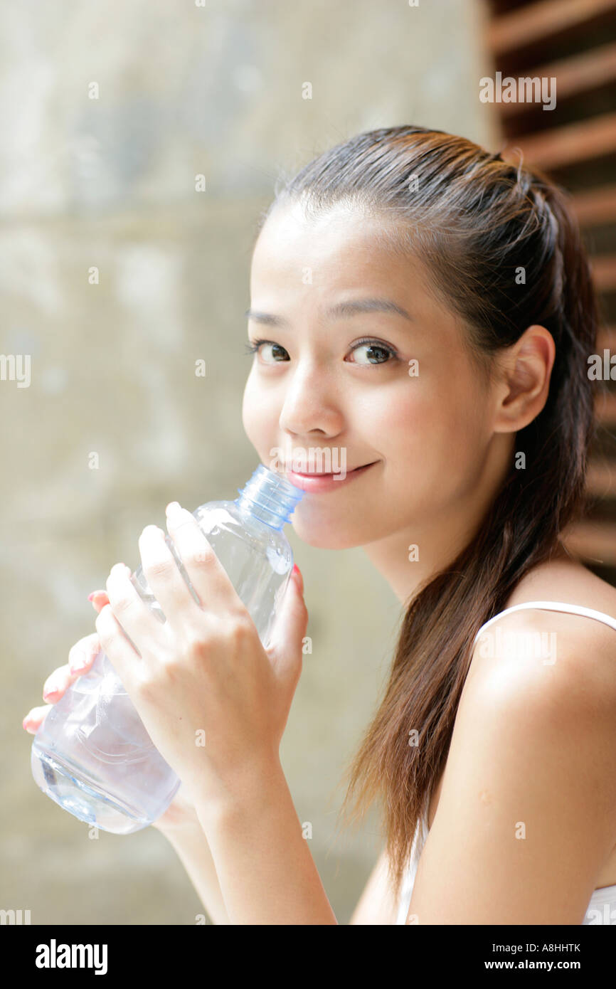 Portrait of a young woman holding water bottle Stock Photo - Alamy Portrait of a young woman holding water bottle Stock Photo - Alamy