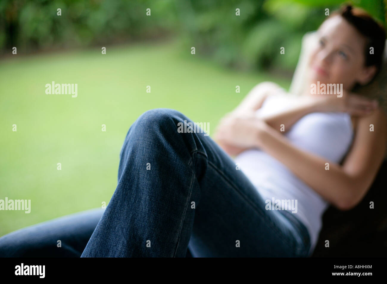 View of a woman lying on a bench Stock Photo - Alamy