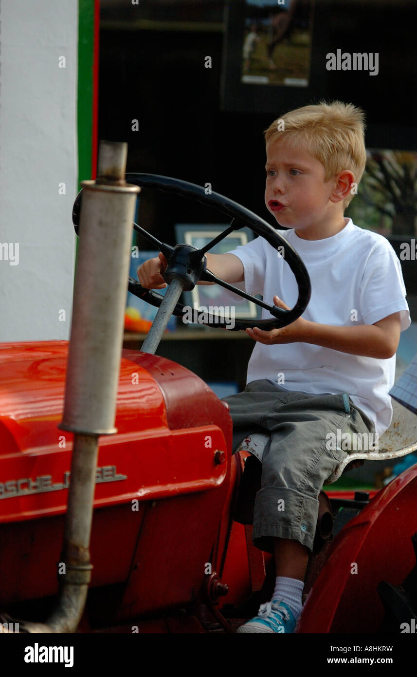 Driving boy on tractor Holland Stock Photo - Alamy