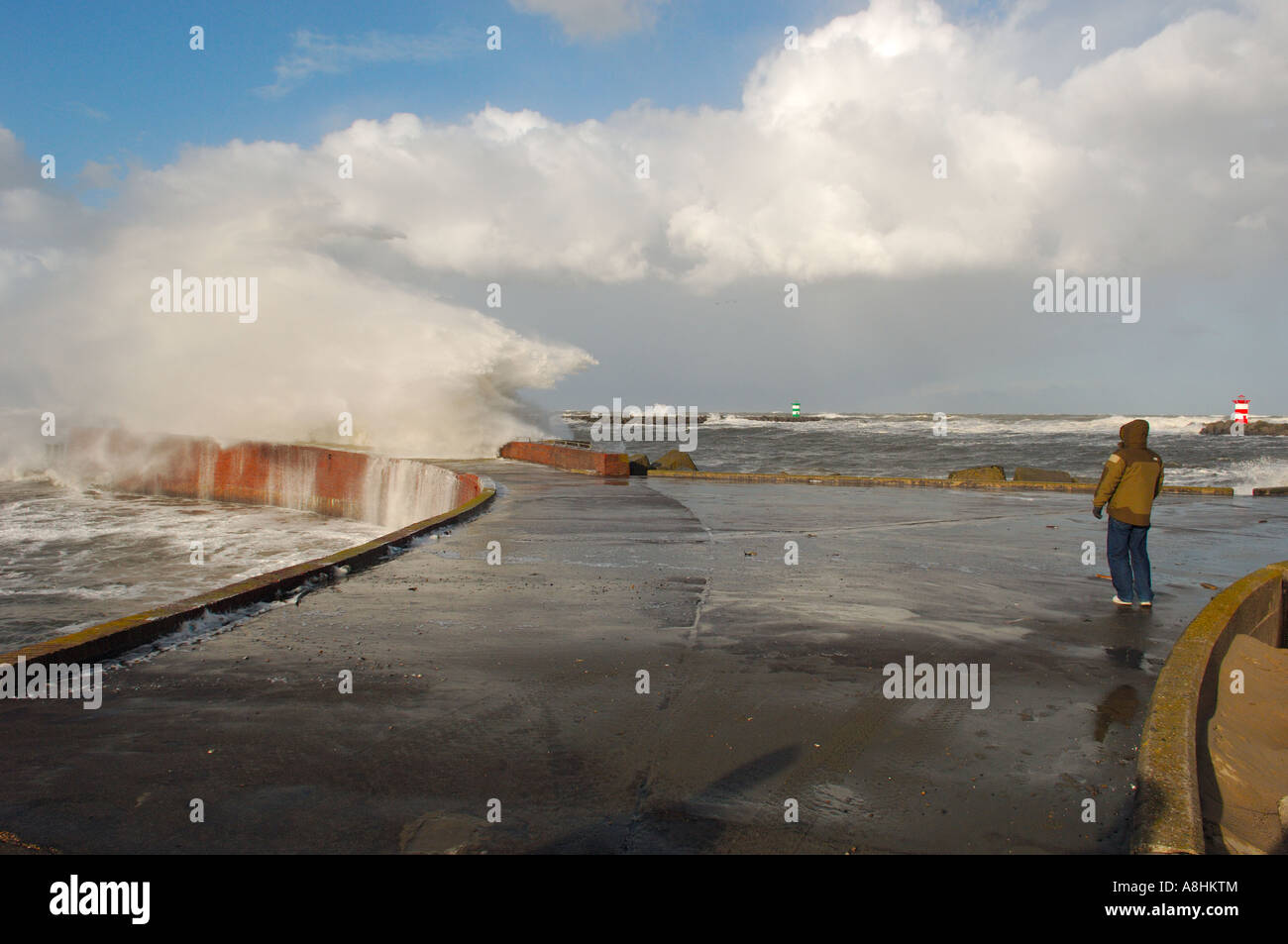 Storm in Scheveningen boy looking on jetty for big wave Holland Stock ...