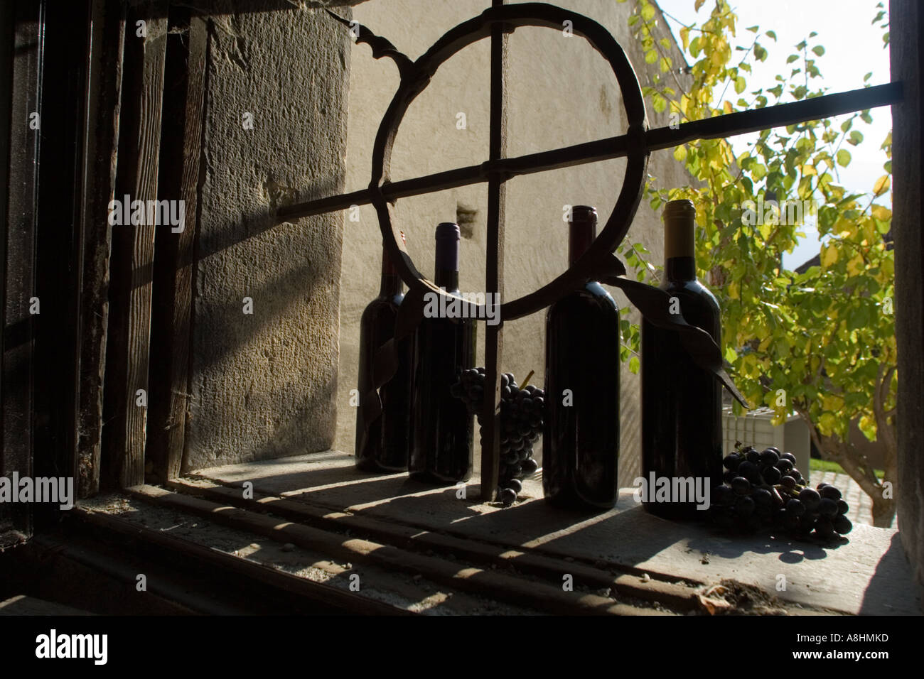 Marble barred window of castle with grapes and bottles of wine Stock ...