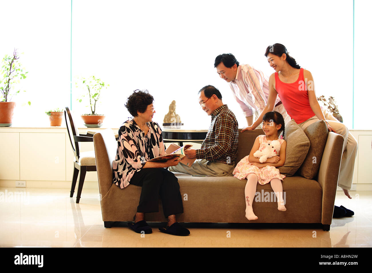 View of a family sitting together Stock Photo - Alamy