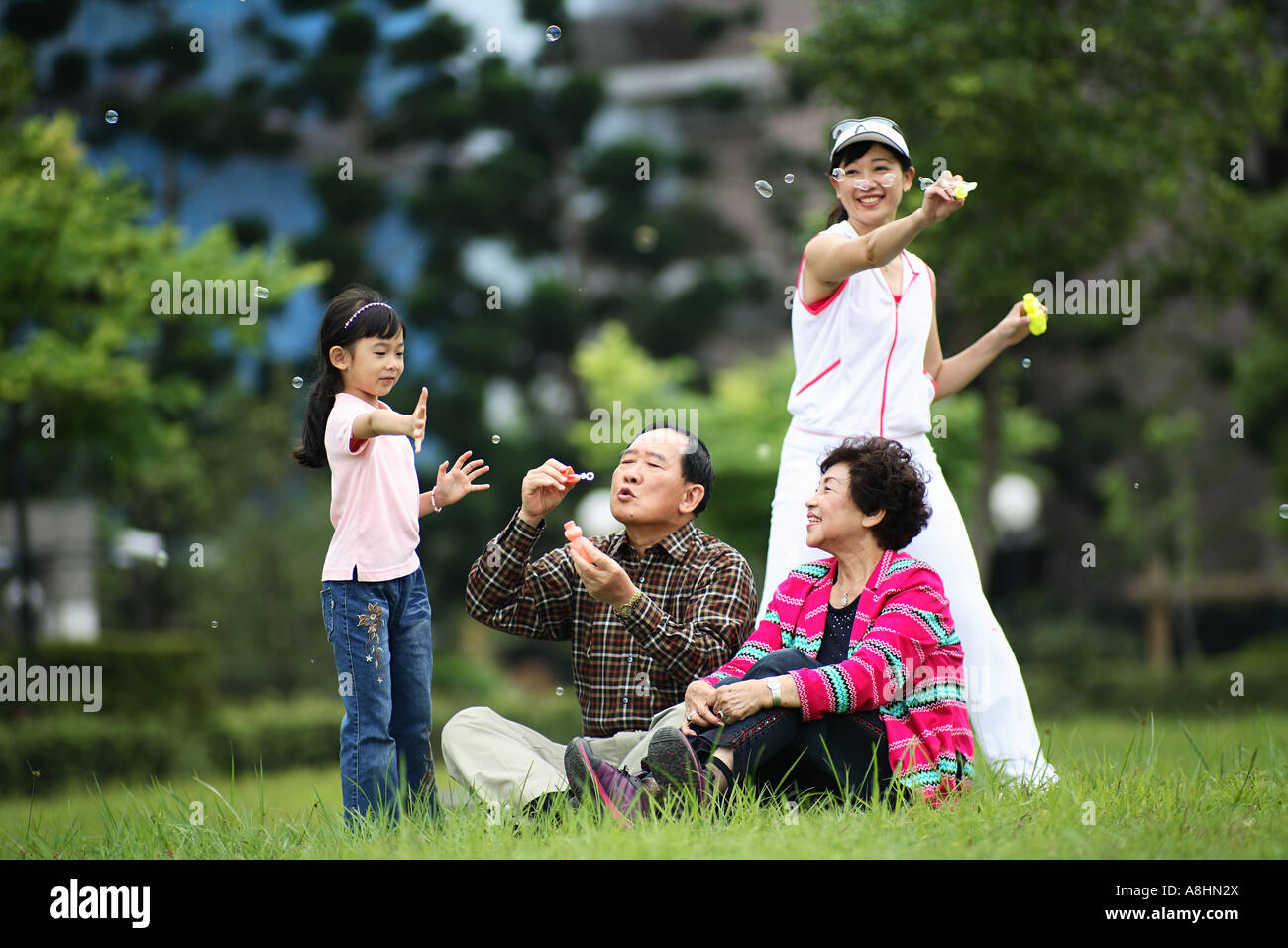 View of a girl enjoying with her family Stock Photo - Alamy