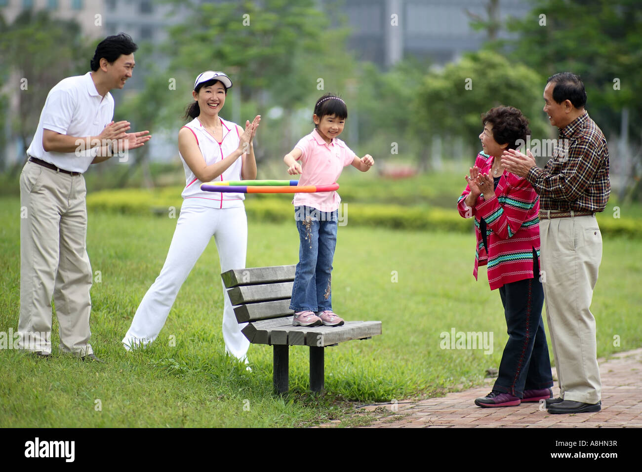 View of parents encouraging their daughter Stock Photo - Alamy
