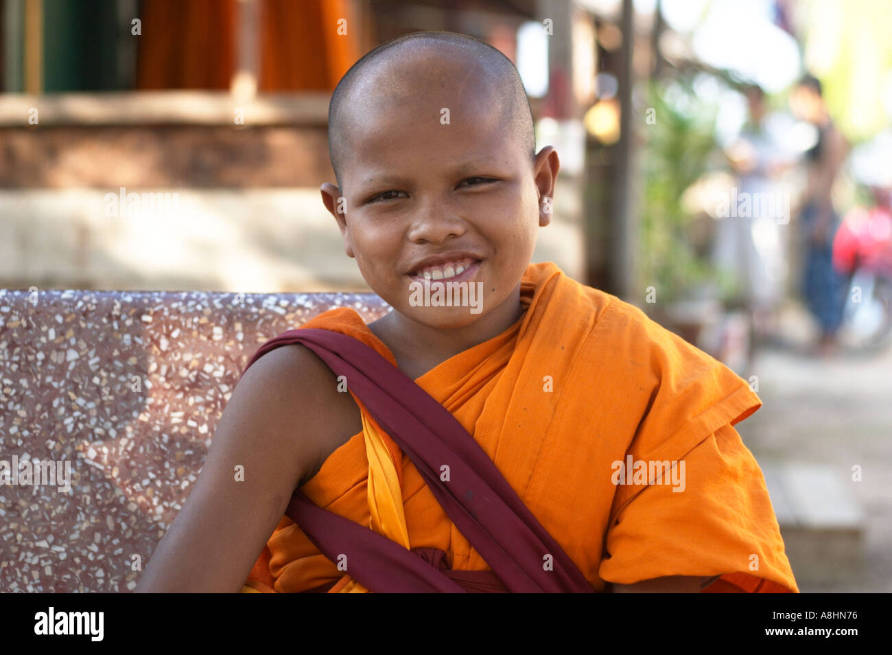 young child buddhist monk sat outside a temple near siem reap in ...