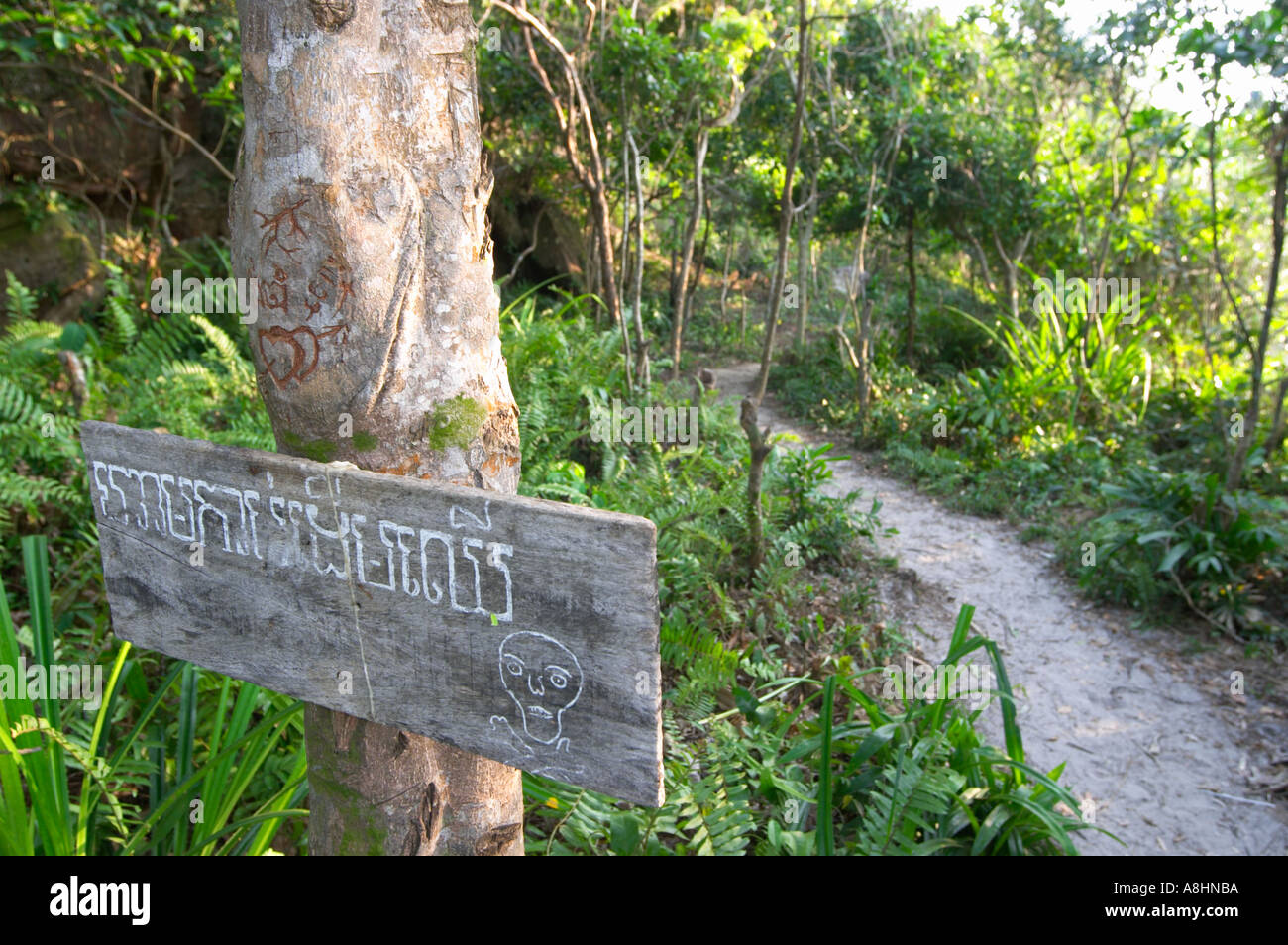 warning sign on a jungle path at the beach resort Sihanoukville in ...