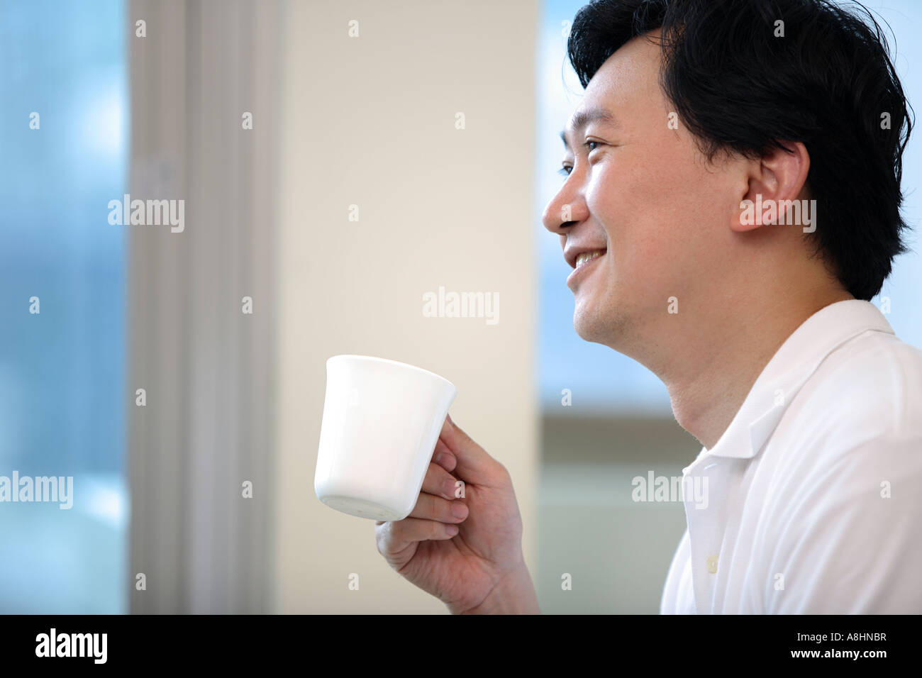 Side view of a man holding a cup Stock Photo - Alamy