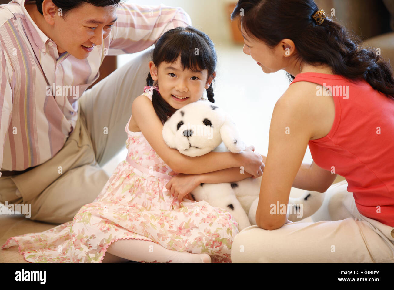 View of a family sitting together Stock Photo - Alamy