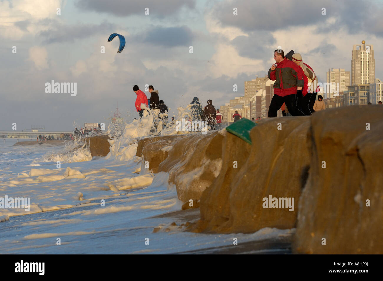 Running people for the wave at Scheveningen beach Stock Photo - Alamy