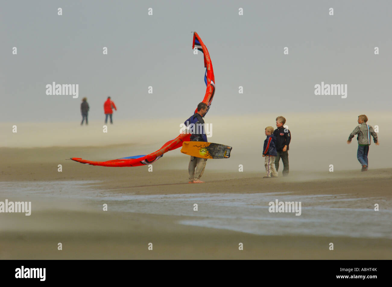 Kite boy is speaking with child on the beach Stock Photo - Alamy
