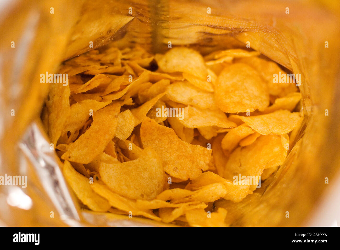 Golden chips in a bag Stock Photo - Alamy