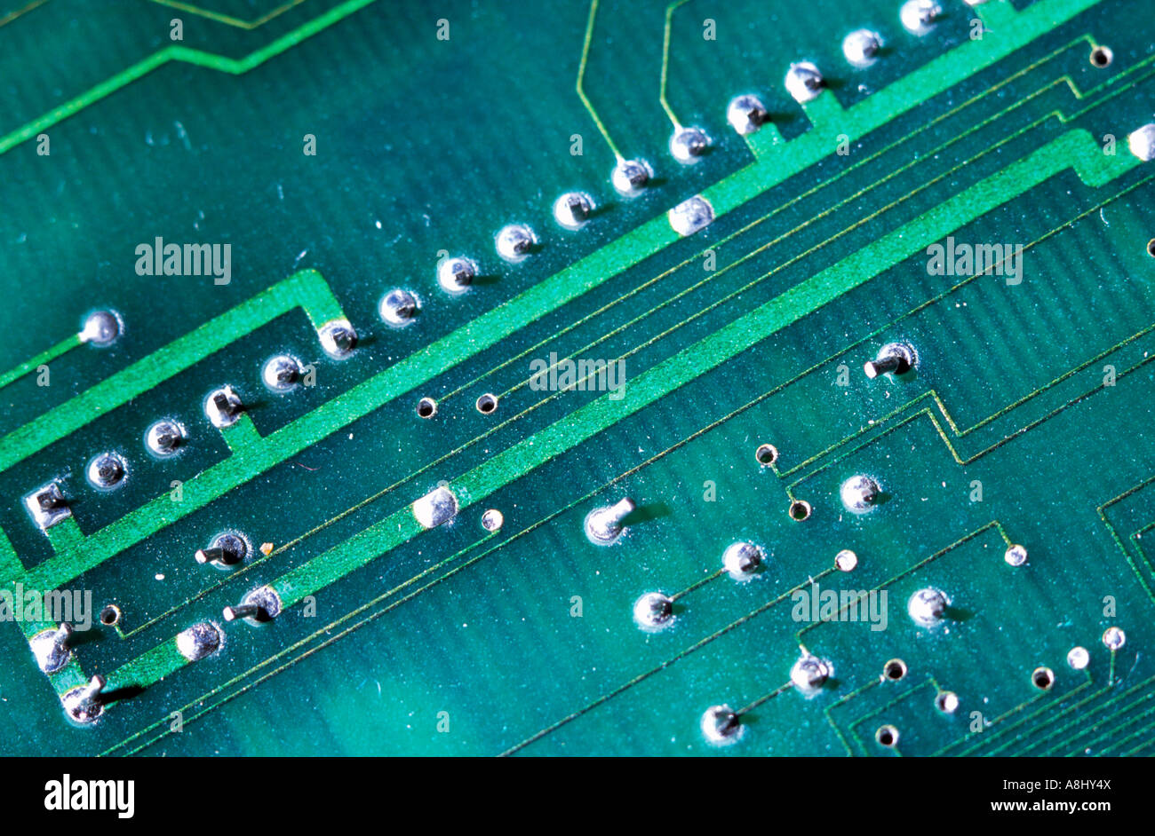 Electronics printed circuit board showing conductive traces and through ...