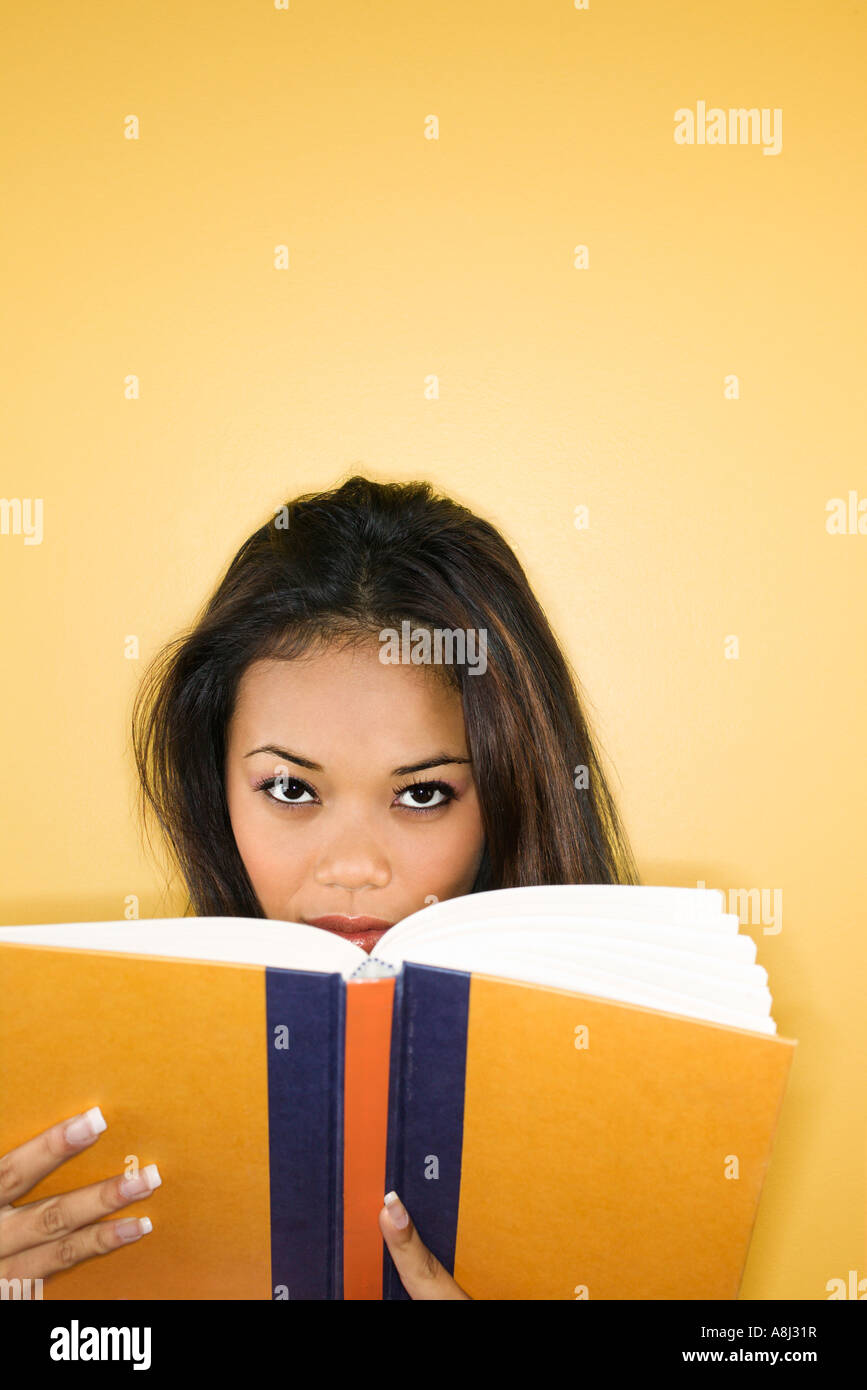 Woman Peering Over Book High Resolution Stock Photography and Images ...