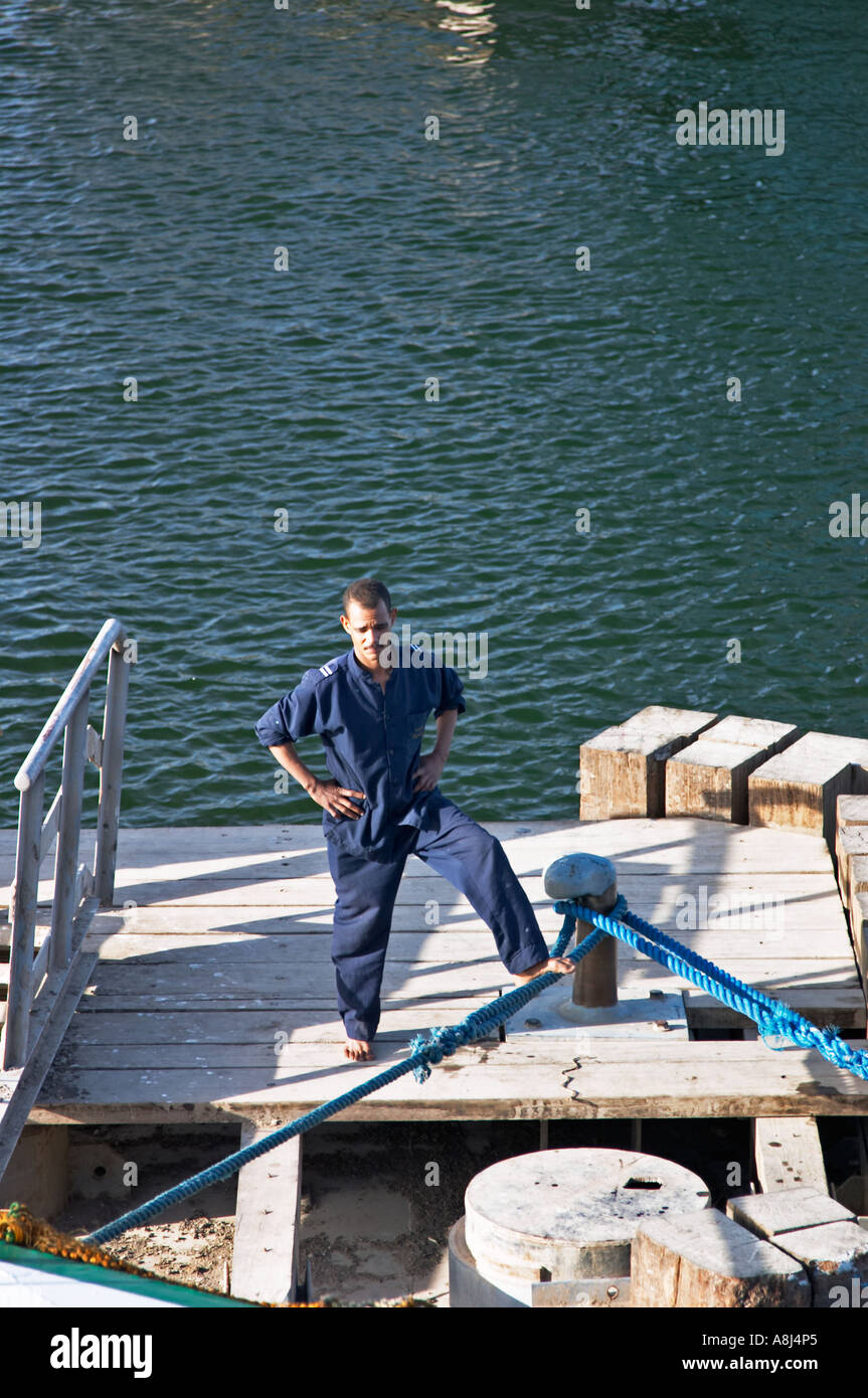 Sailor securing a Hauser rope on a bollard at Esna Lock, Egypt Stock ...