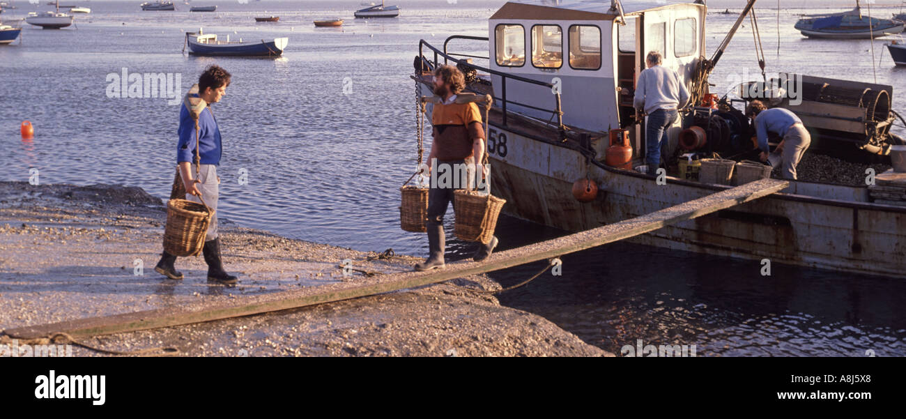 1980s archive view men at walking plank using shoulder yokes to carry ...
