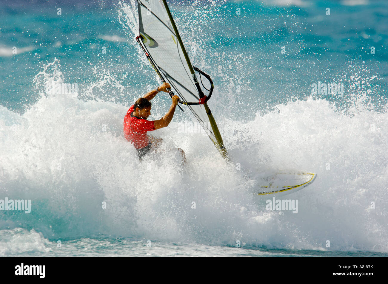 Windsurfing on Barbados men on the bleu wave s in the middle of the ...