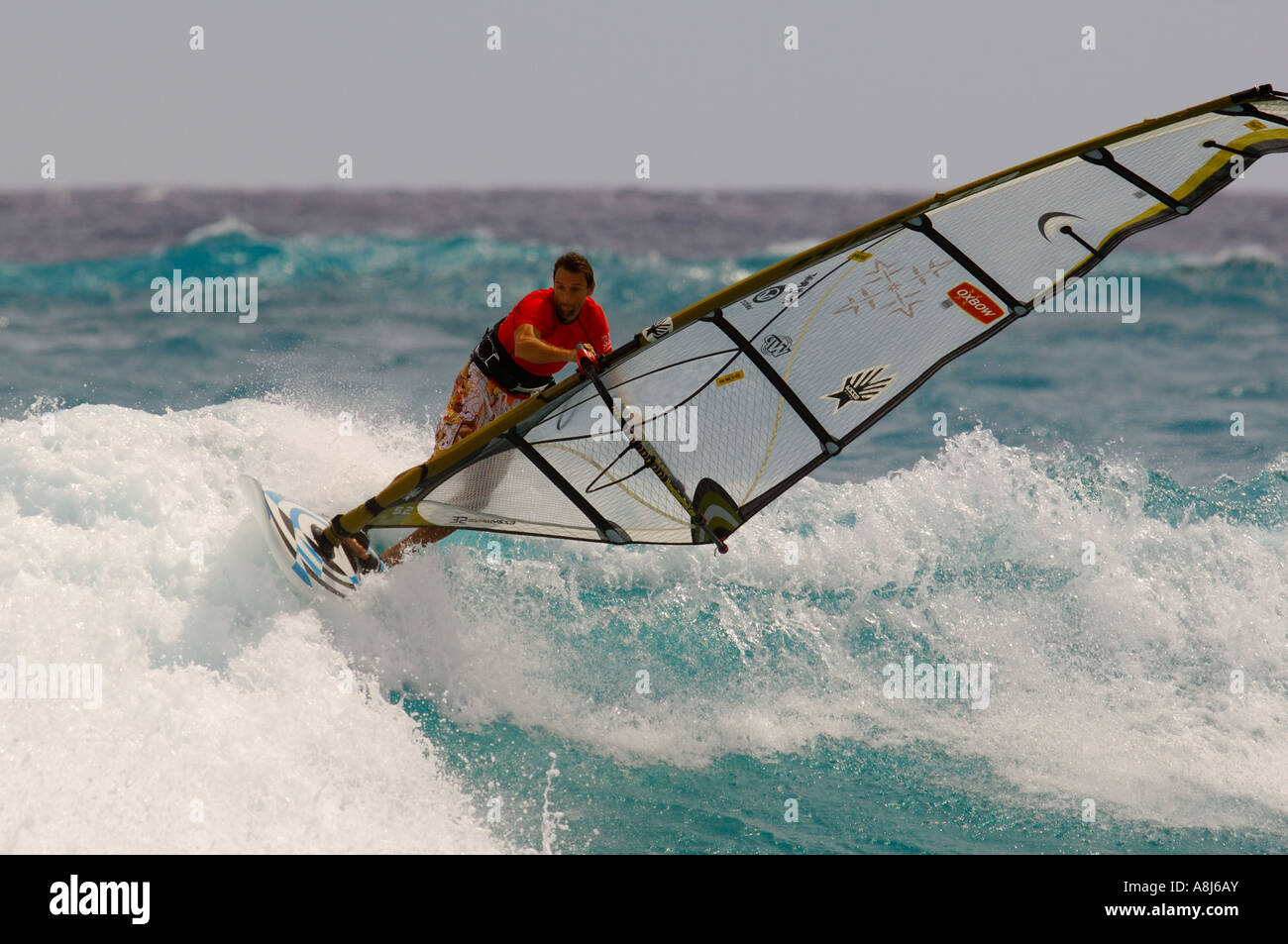 Windsurfing on Barbados men on the bleu wave s Stock Photo - Alamy