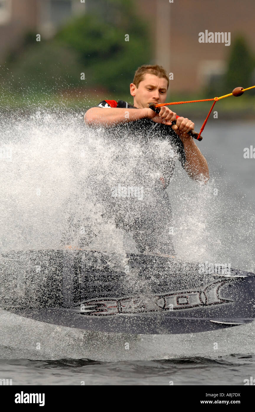 People Wakeboarding on lake boy jumping Stock Photo - Alamy