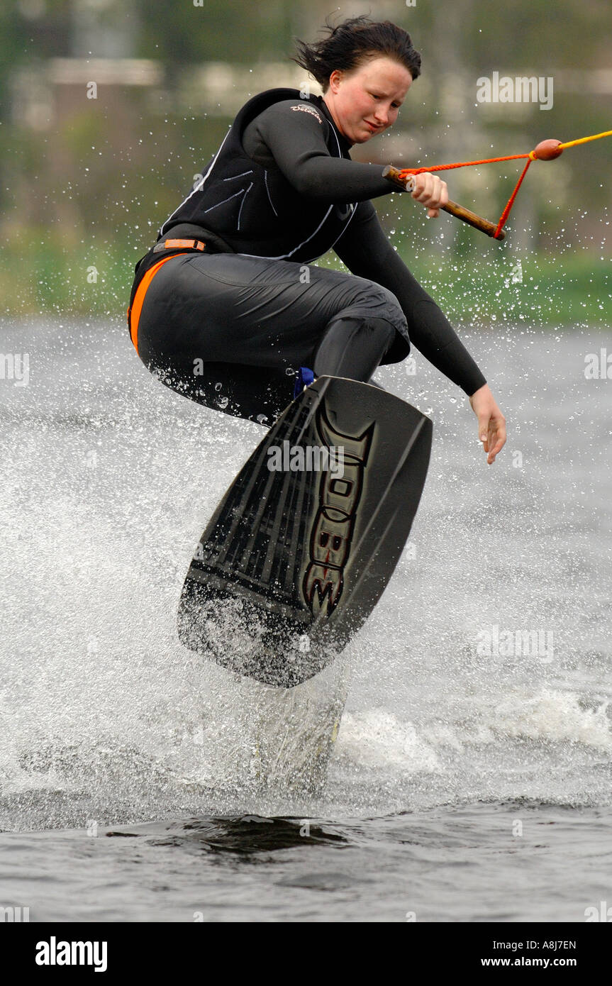 People Wakeboarding on lake girl jumping Stock Photo - Alamy