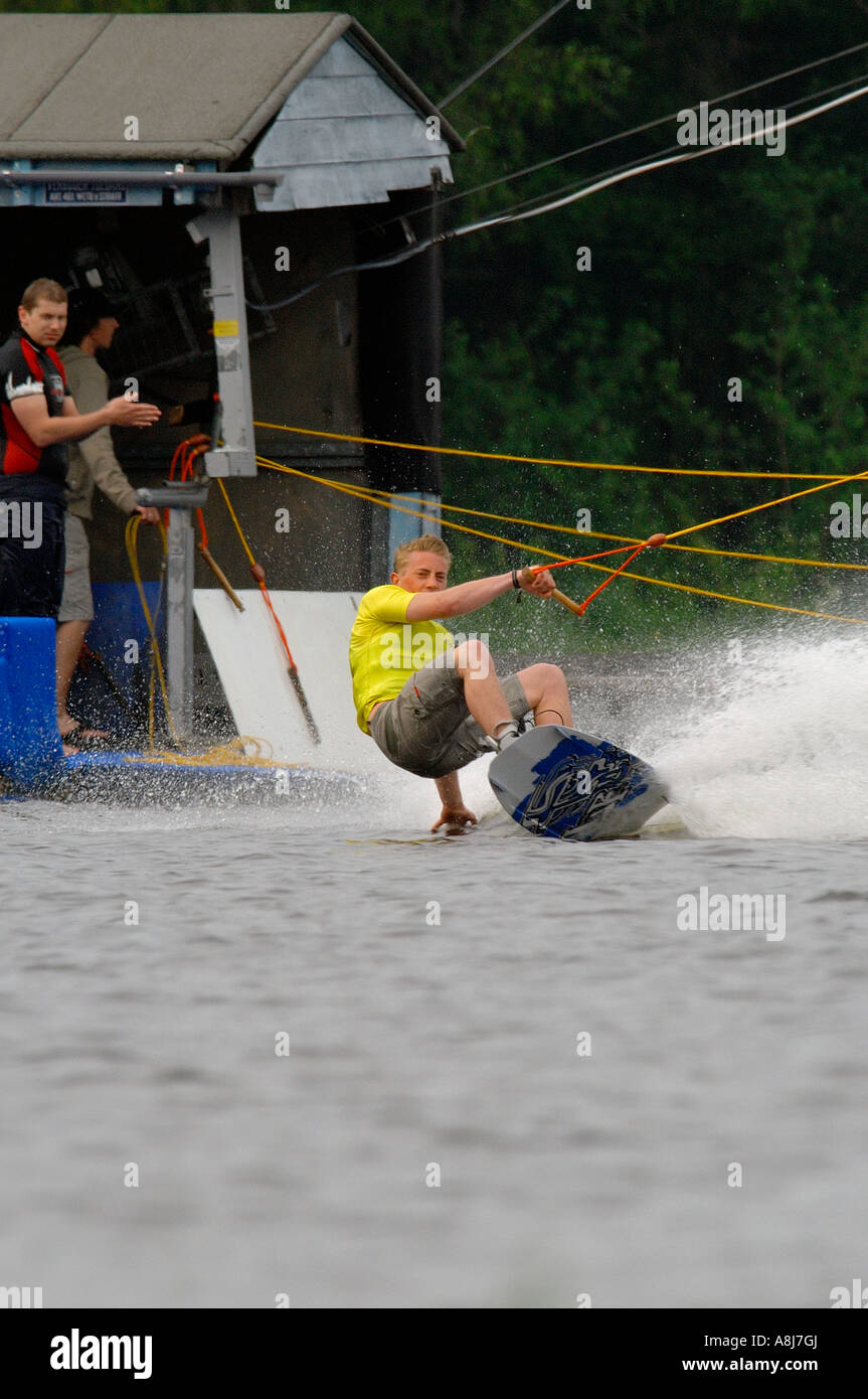 People Wakeboarding on lake boy make big spray with background with ...