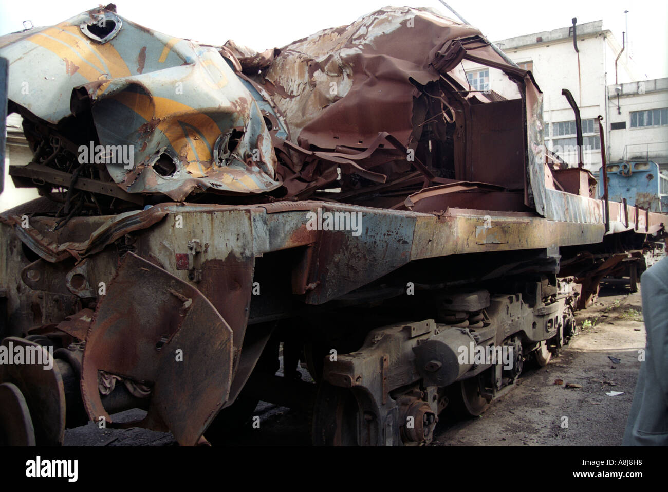 A damaged train engine destroyed by a terrorist attack waits in a ...