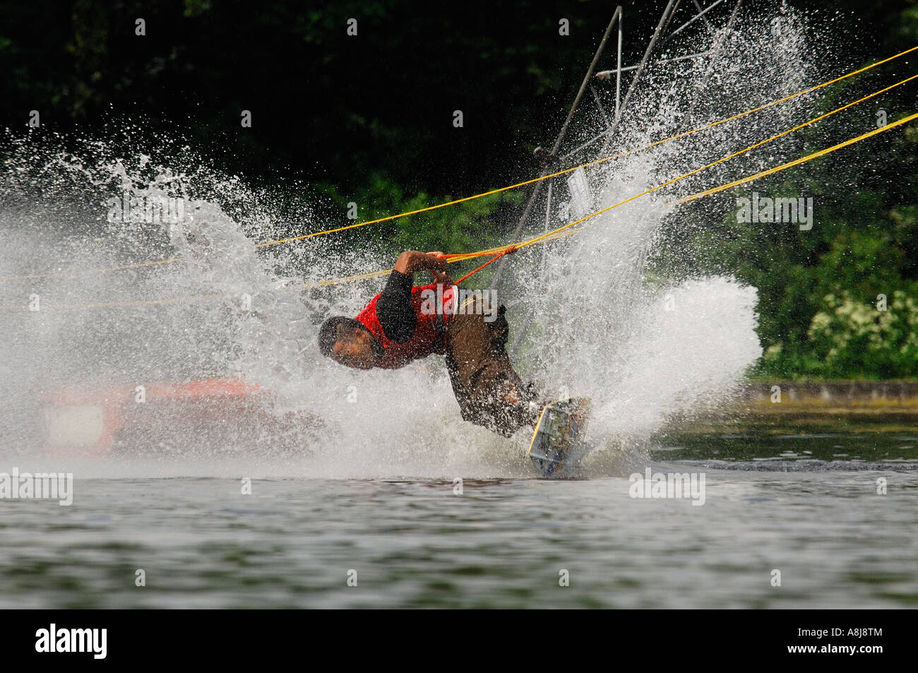 Wakeboarding boy close shot on the flat water 2006 with background wit ...