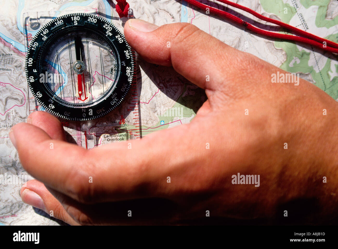 Man using compass on map hi-res stock photography and images - Alamy
