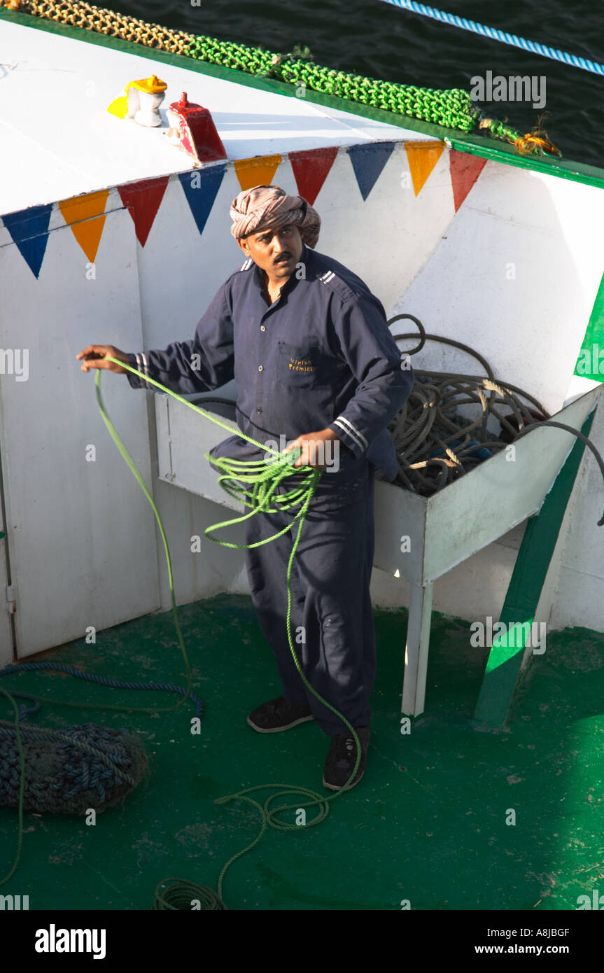 Sailor with a Hauser rope on a Nile cruise ship at Esna Lock, Egypt ...