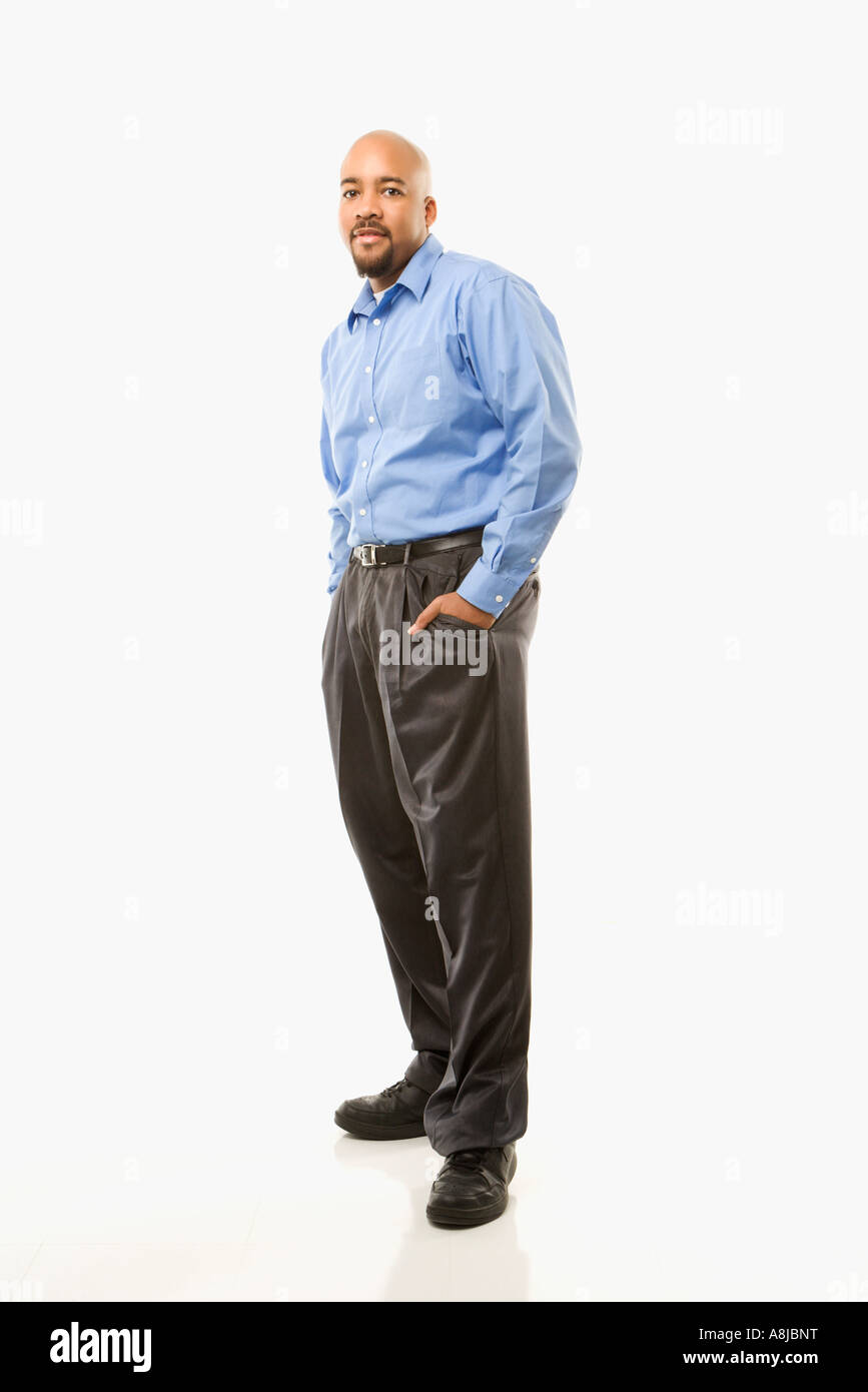 Portrait of African American man standing against white background ...
