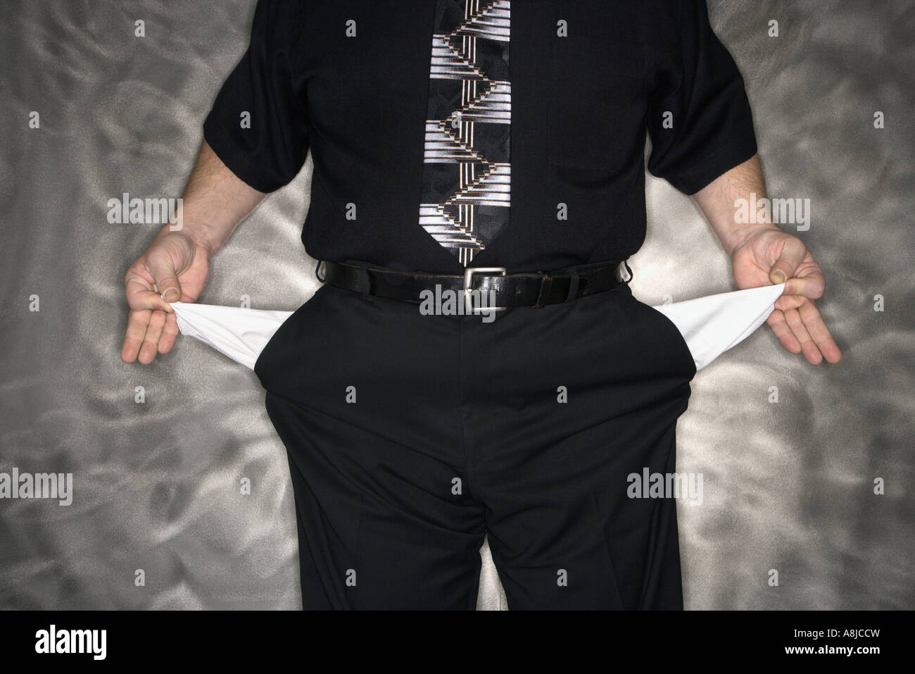 Caucasian mid adult man pulling out empty pants pockets Stock Photo - Alamy