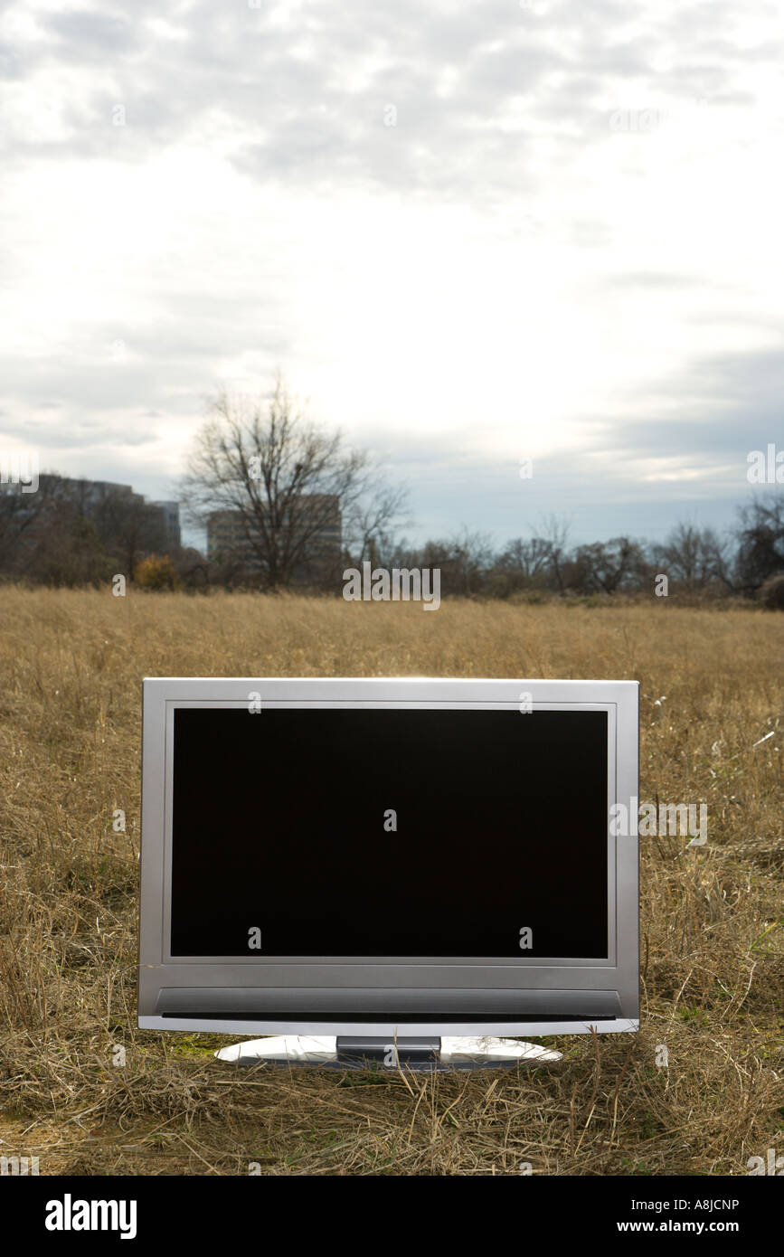 Flat panel television set in grassy field Stock Photo - Alamy